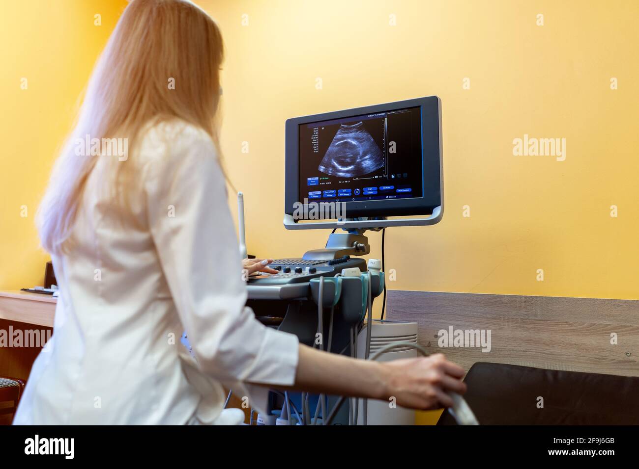 the doctor looks at the monitor of the ultrasound machine Stock Photo ...