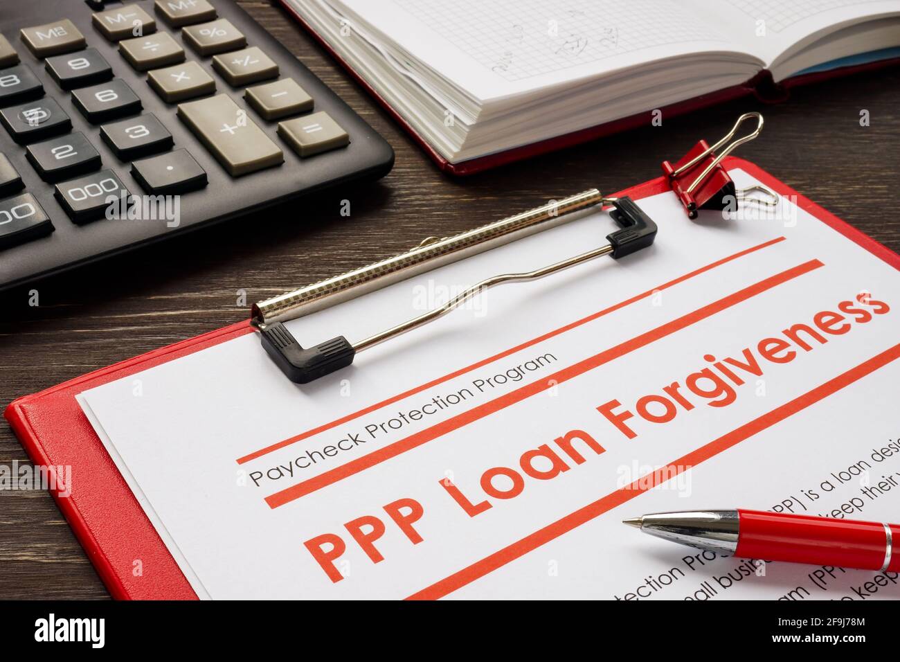 PPP loan forgiveness form and red notebook Stock Photo - Alamy