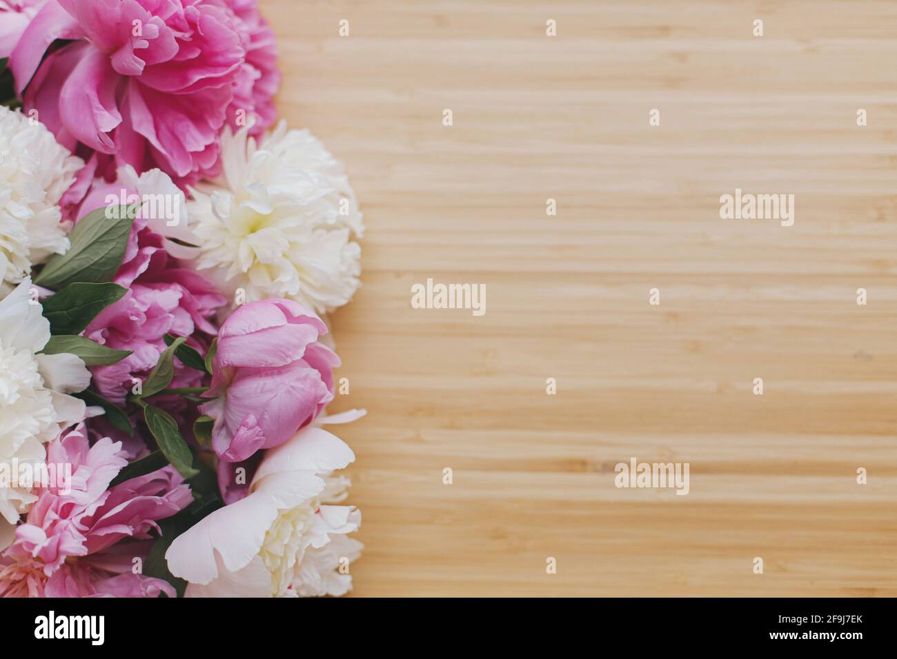 Peony bouquet on wooden background top view with space for text. Pink ...