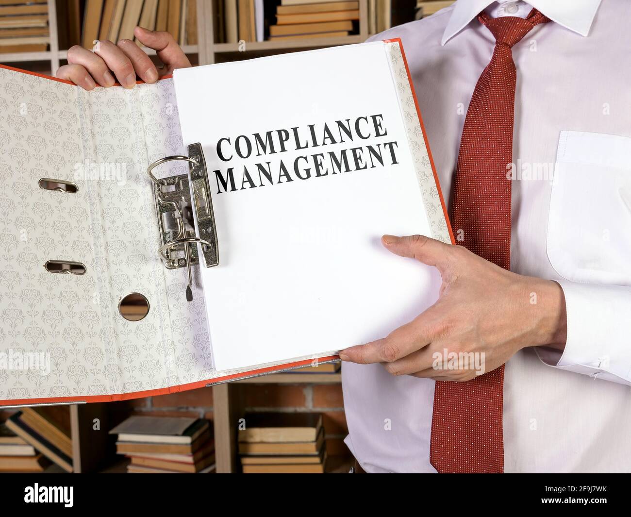Manager shows folder with compliance management documents Stock Photo ...