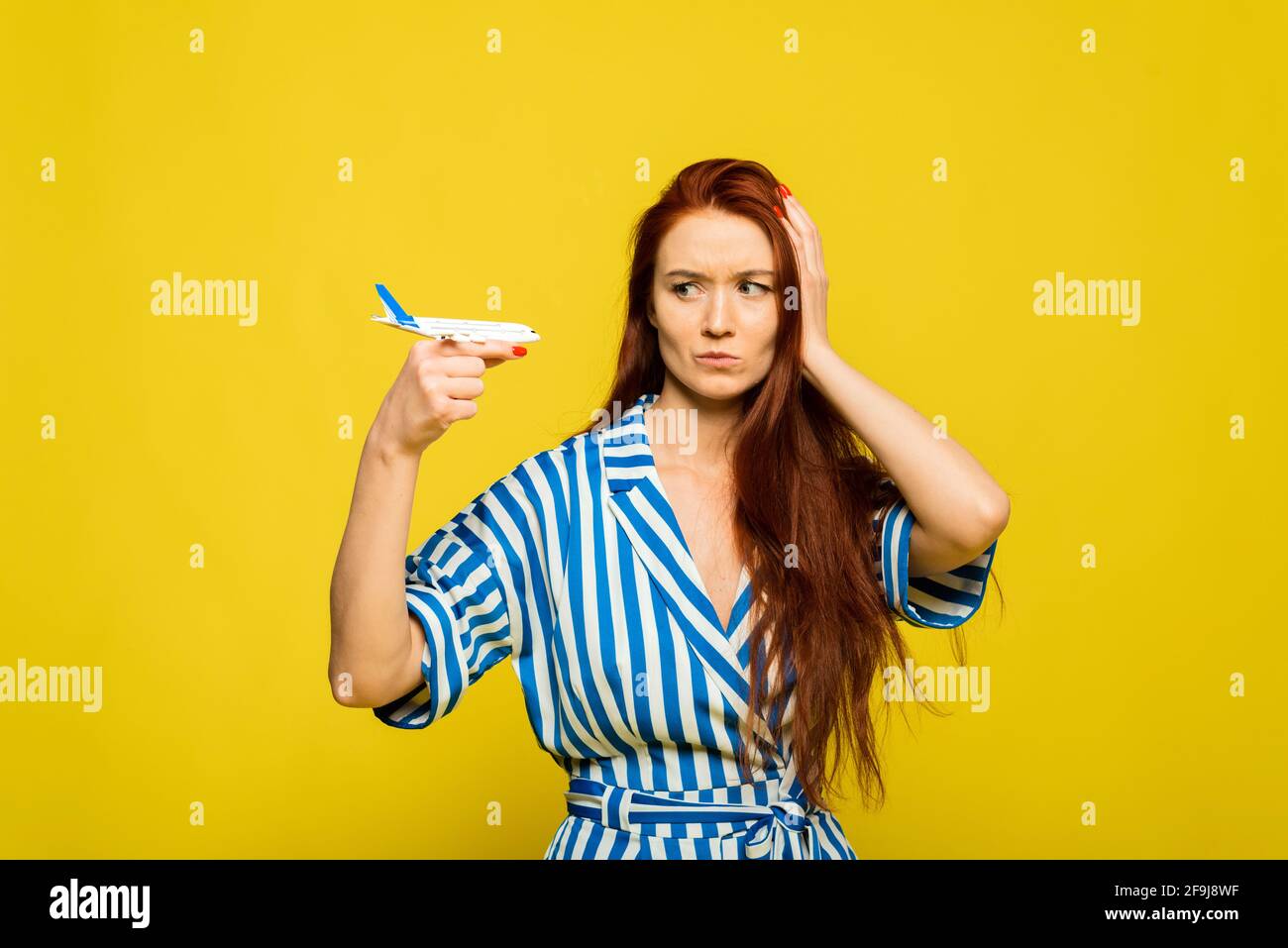 Air flight journey concept. Young beautiful redhead woman holding ...