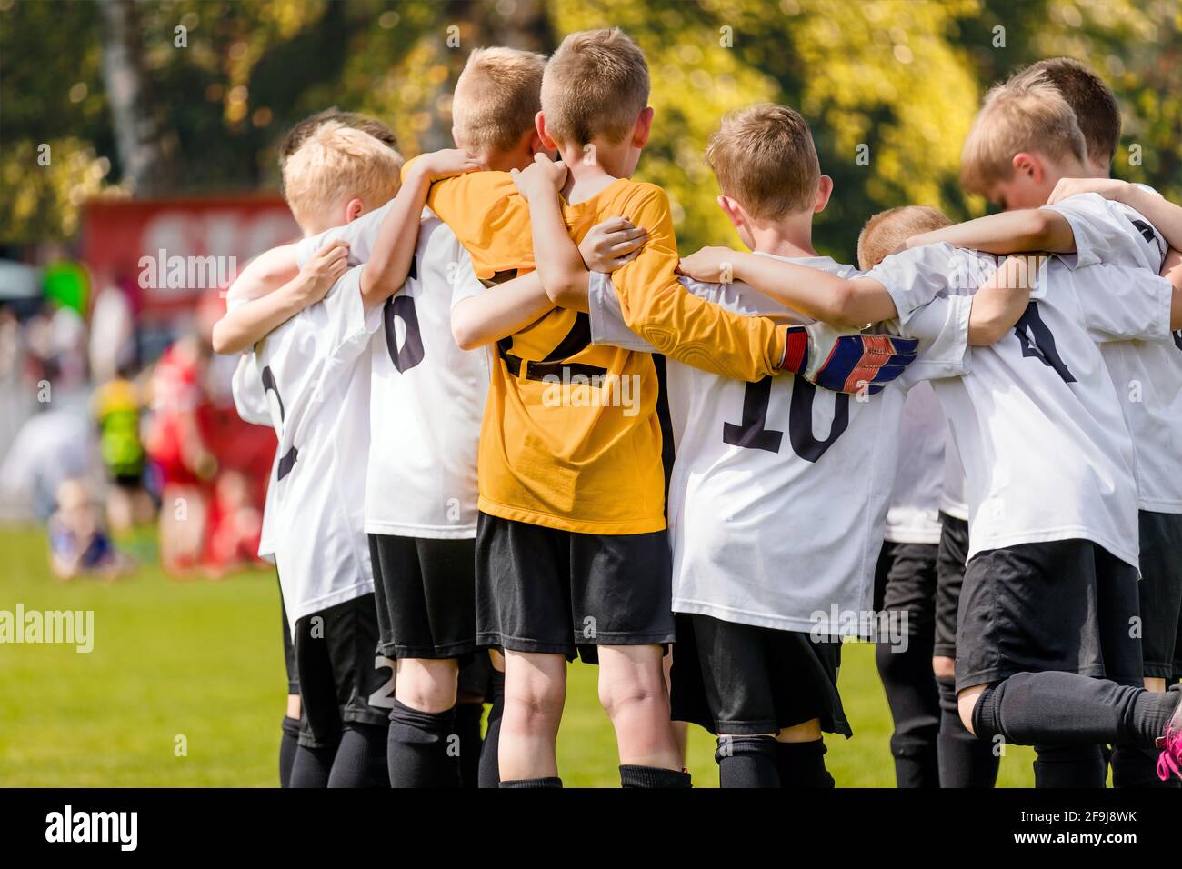 Group of happy sports boys huddling in a team. Happy school kids play ...
