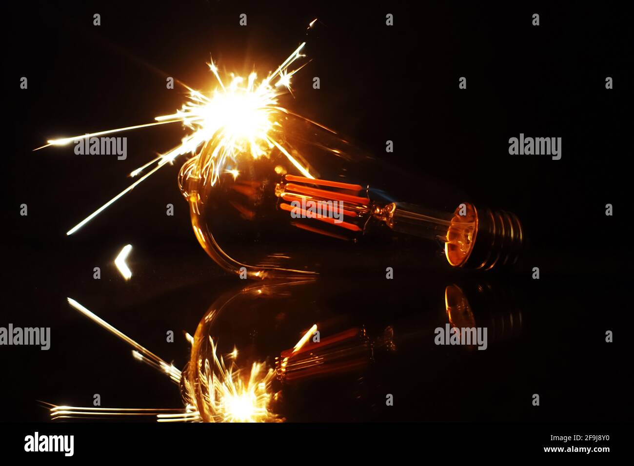 vintage light bulb with spark of fire Stock Photo - Alamy