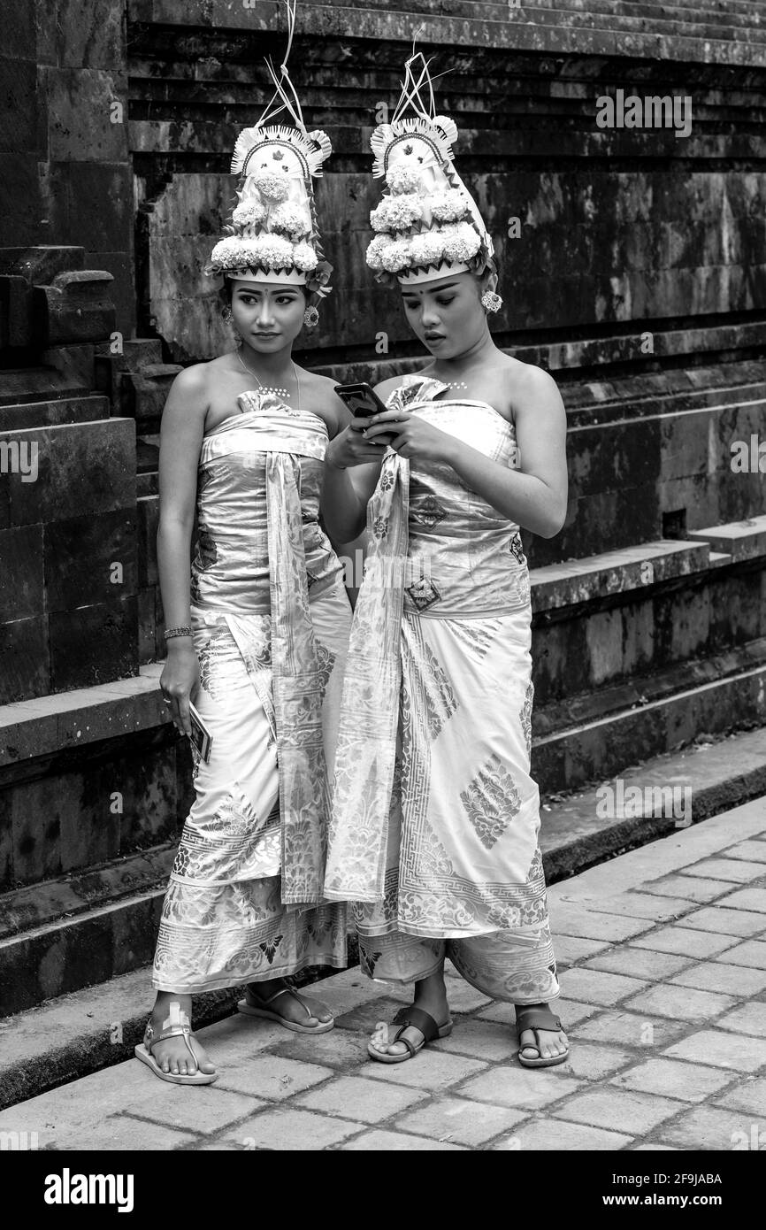 Two Young Balinese Hindu Females Looking At A Mobile Phone (Cell Phone ...
