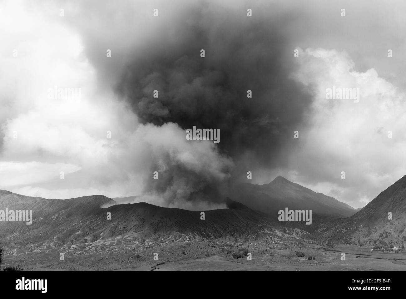 An Elevated View Of Mount Bromo (Erupting) and The Sea Of Sand, Bromo ...