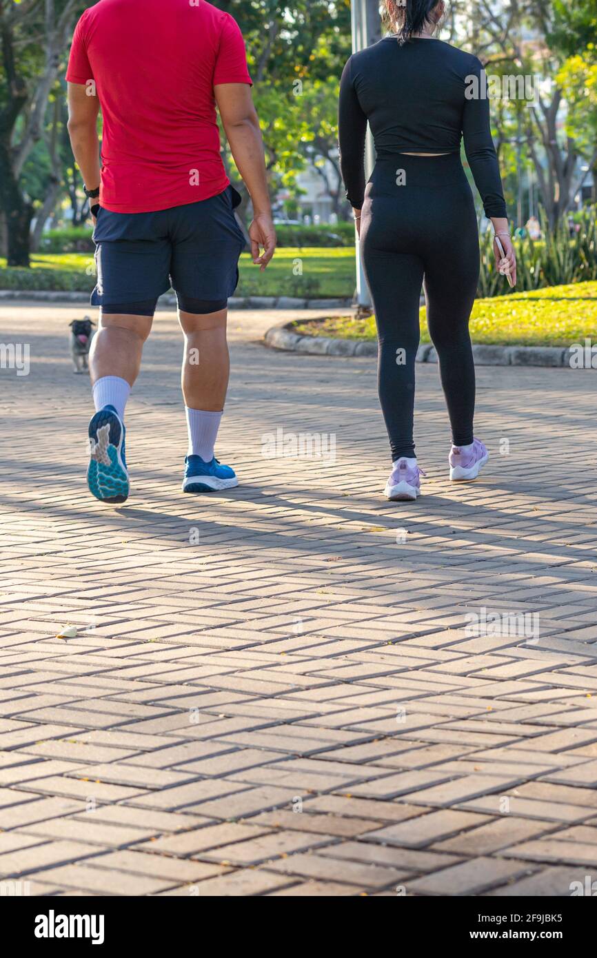 People in sportwear outfit walking in the park Stock Photo - Alamy