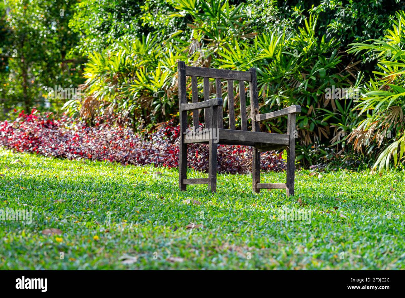 Rustic wooden chair on grass lawn with beautiful garden background ...