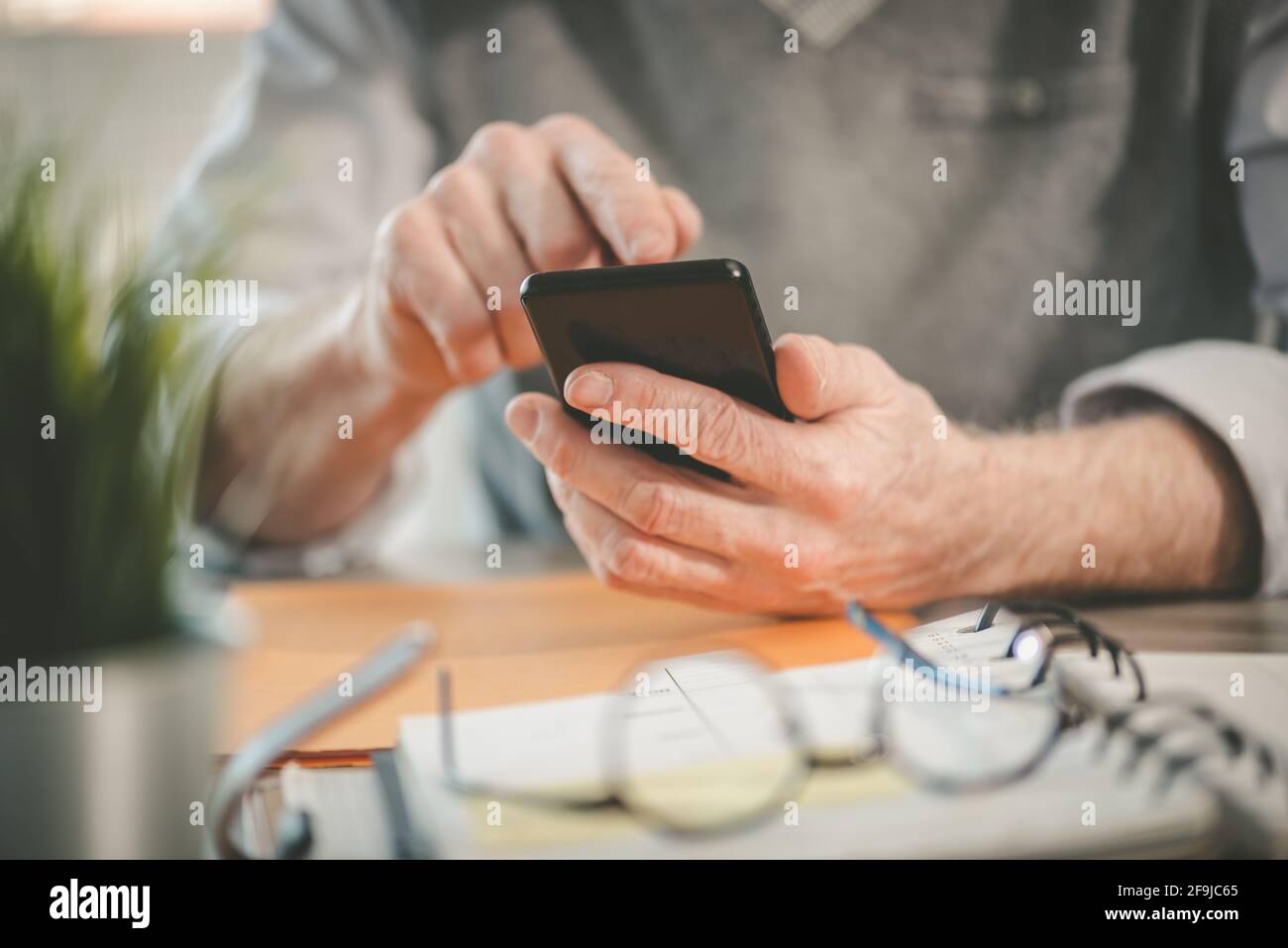 Male hands using mobile phone Stock Photo - Alamy