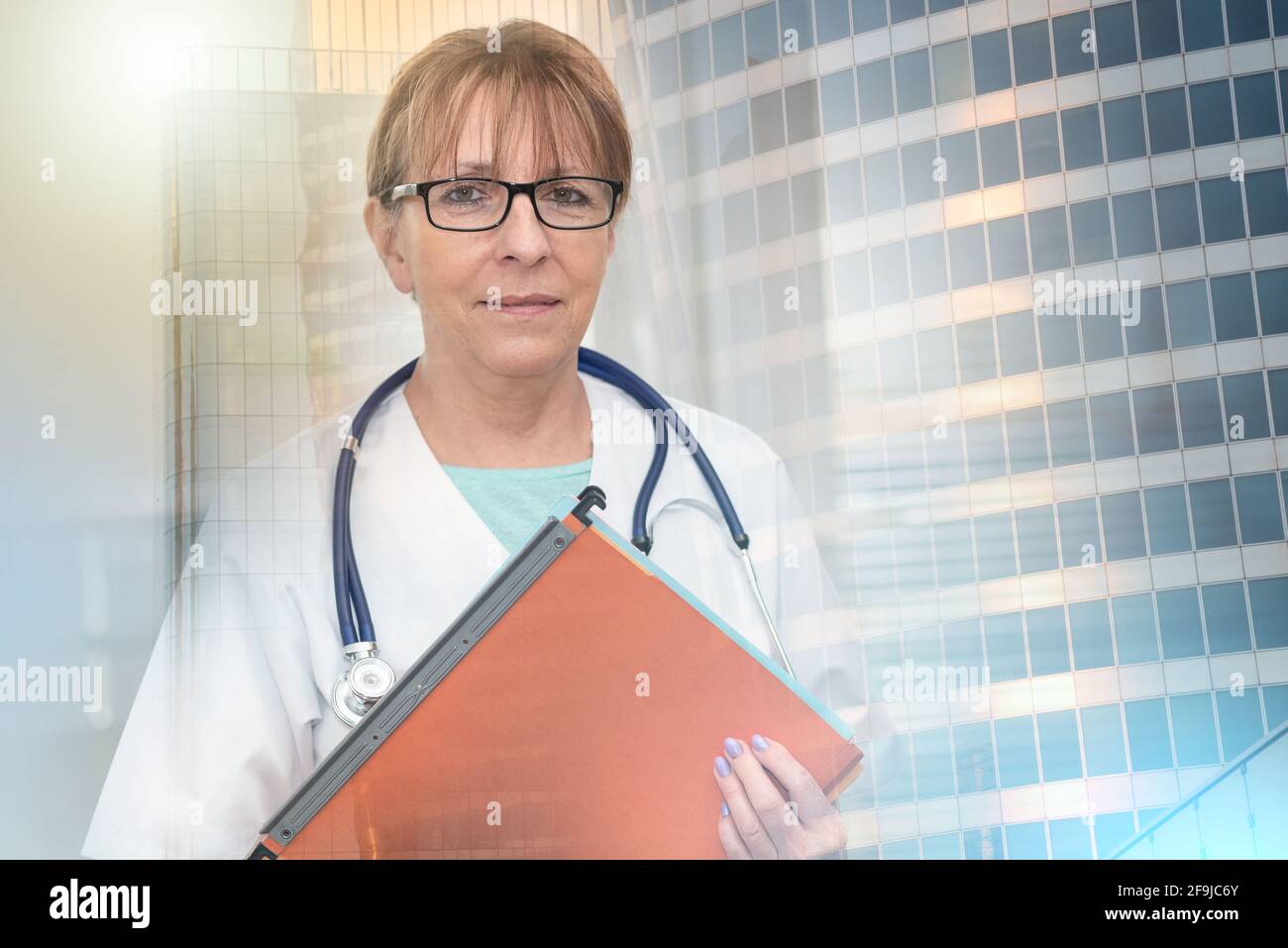 Portrait of female doctor standing and holding a folder; multiple ...