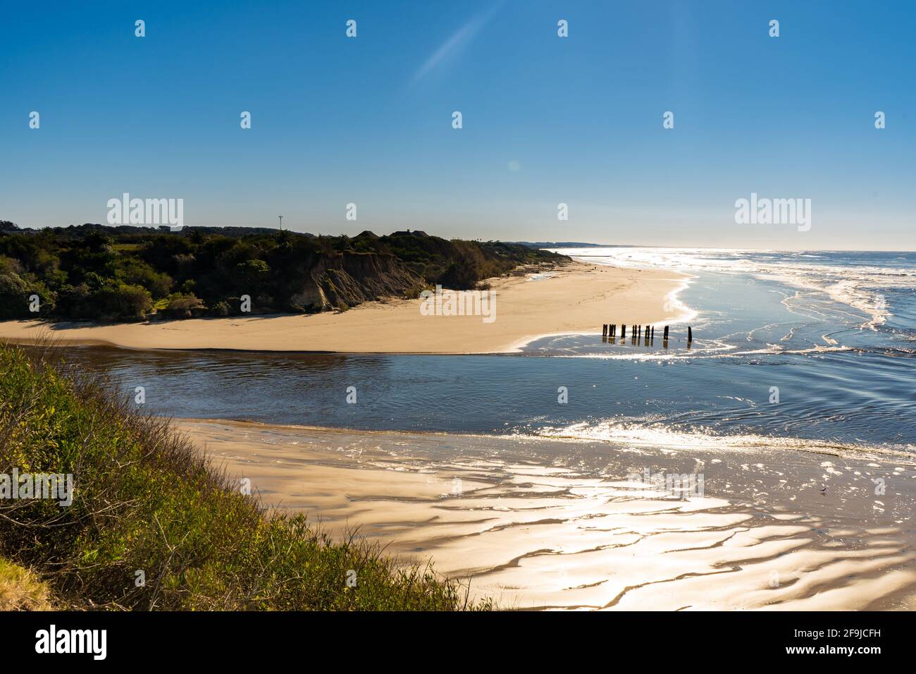 Beautiful view of people standing in the water on the beach and the ...