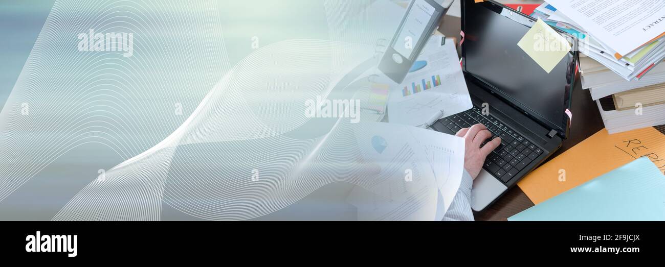 Businessman working at an untidy and cluttered desk; panoramic banner ...