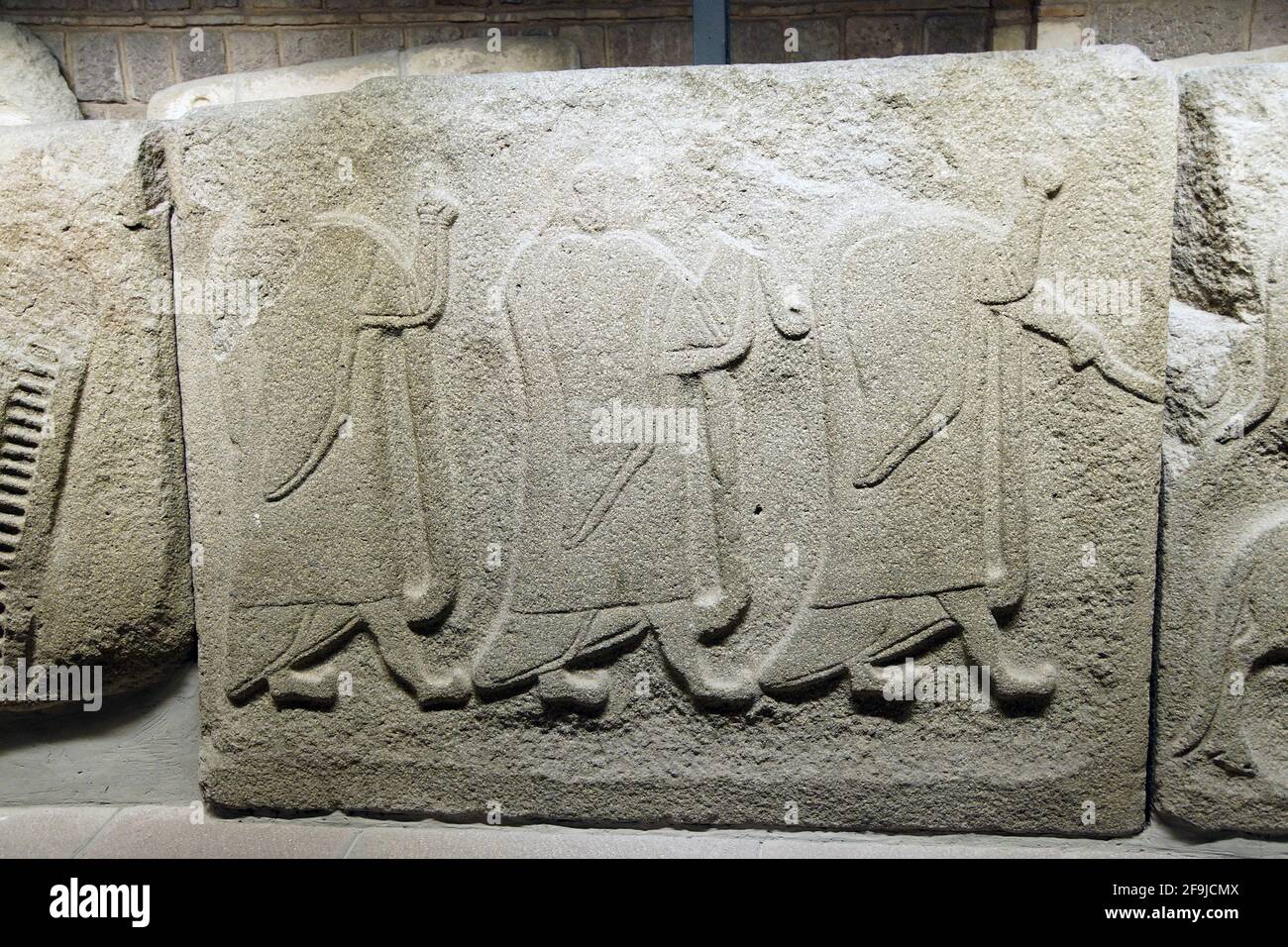 Rock carving of three walking man Stock Photo - Alamy