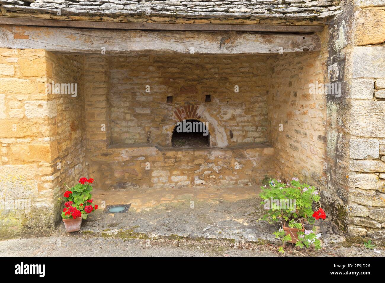 An aged communal bread oven in the pretty village of Archignac, in the ...