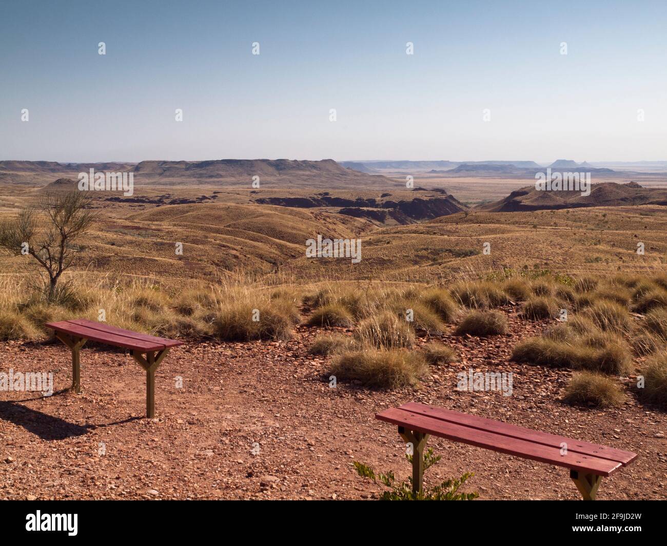 Empty bench seats, spinifex and desert mesas of the Chichester Range ...