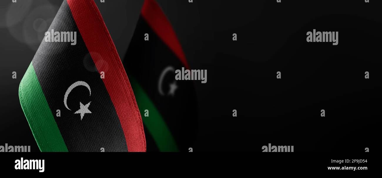Small national flags of the Libya on a dark background Stock Photo - Alamy