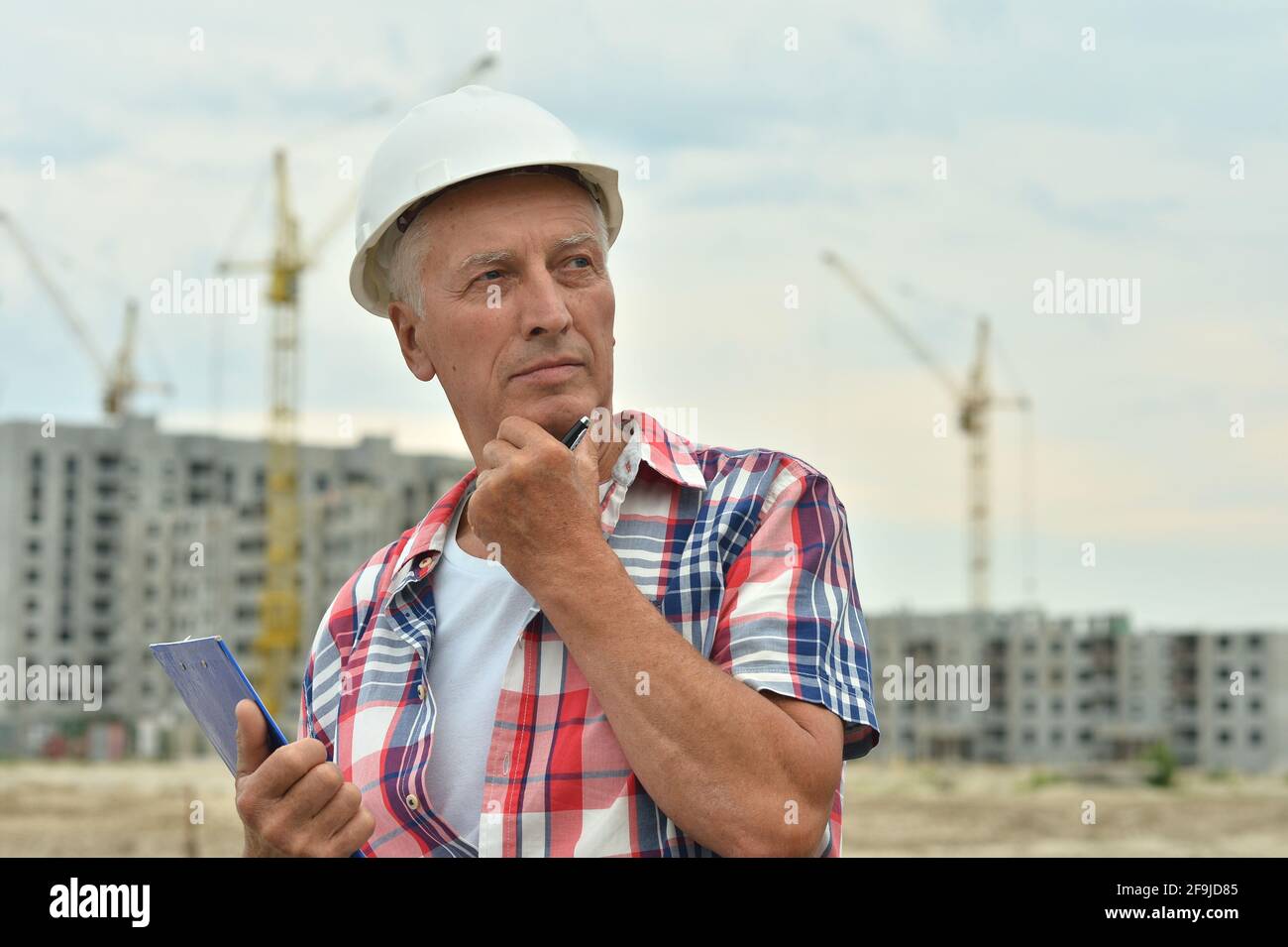 Portrait of senior man in construction site Stock Photo - Alamy