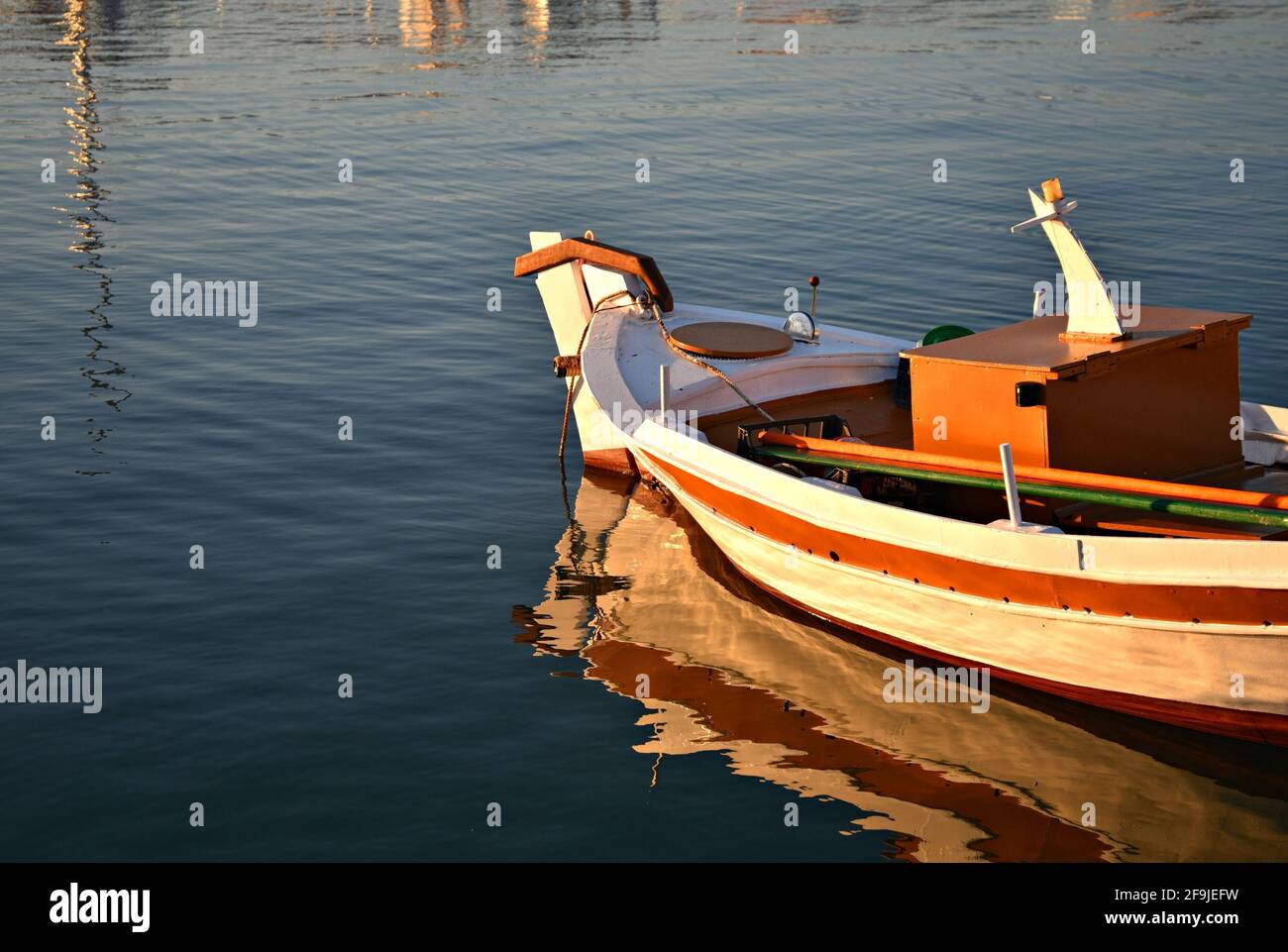 Traditional Greek fishing boat port side with reflection Stock Photo ...