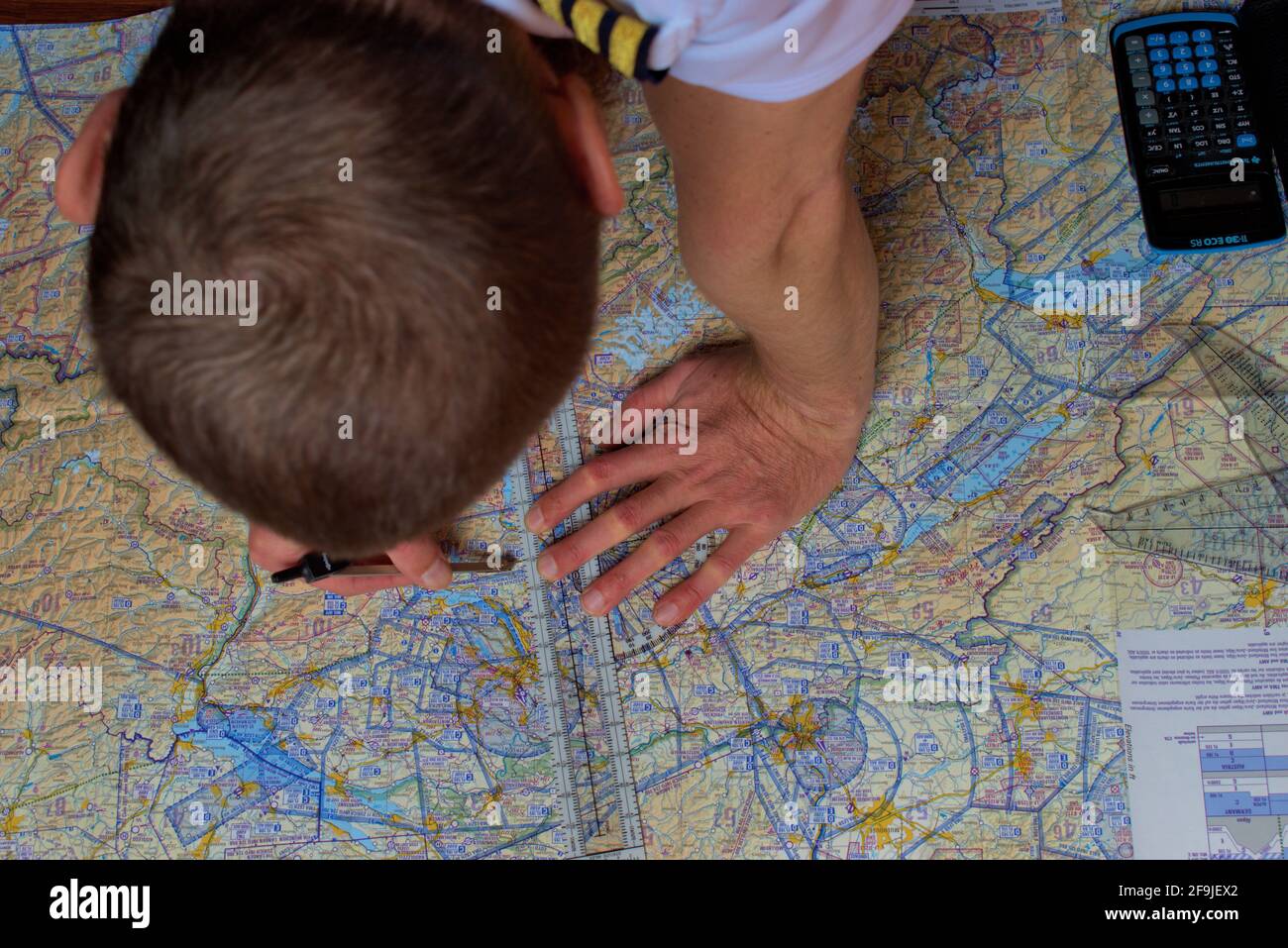 Pilot is calculating his navigation route on an actual map 25.3.2021 ...