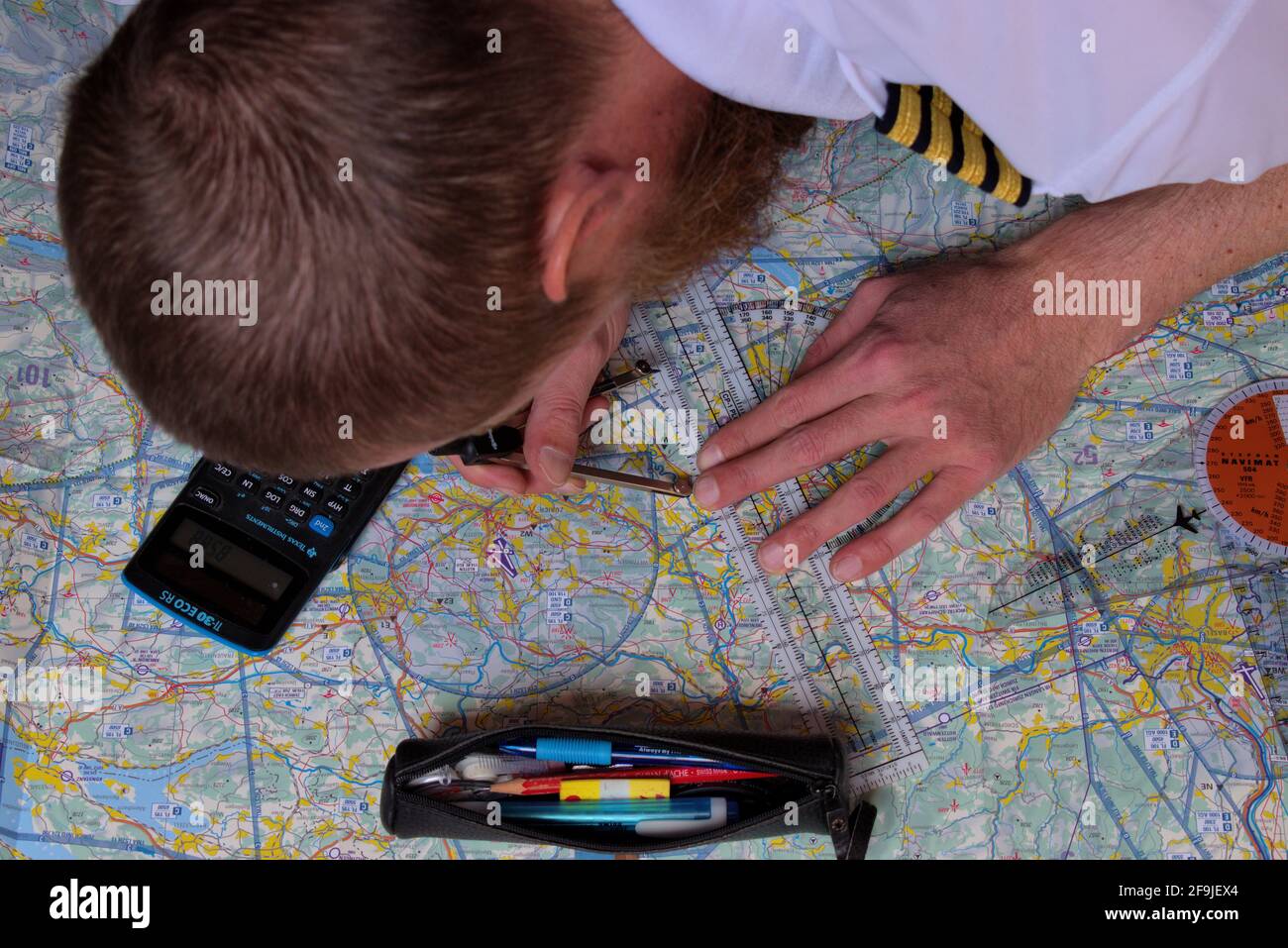 Pilot is calculating his navigation route on an actual map 25.3.2021 ...