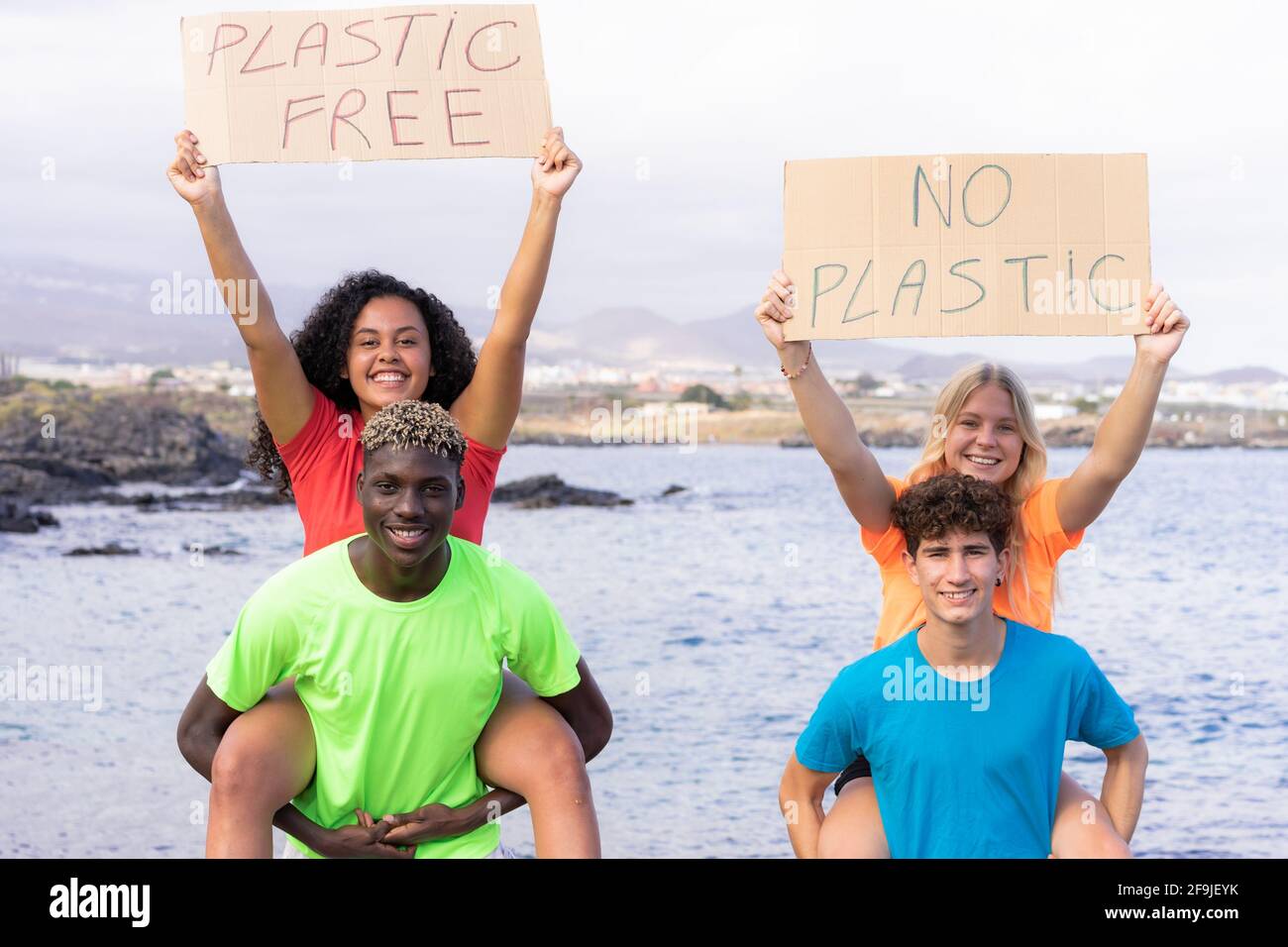 Smiling volunteer people showing posters " plastic free and no plastic ...