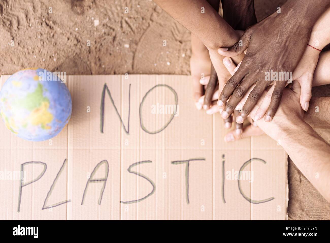 There is a sign that says "NO PLASTIC". Team ready to clean the world ...