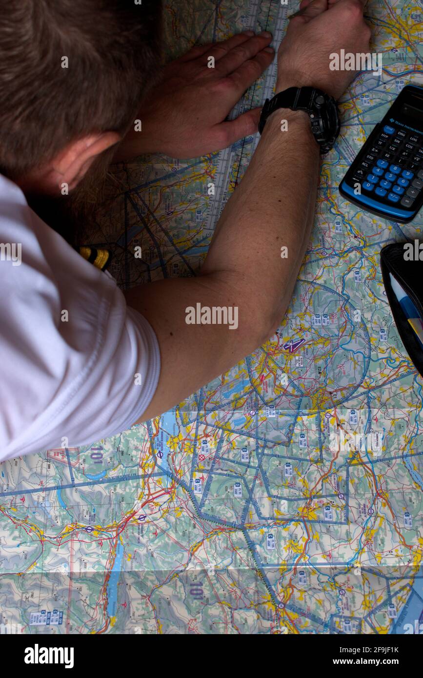 Pilot is calculating his navigation route on an actual map 25.3.2021 ...