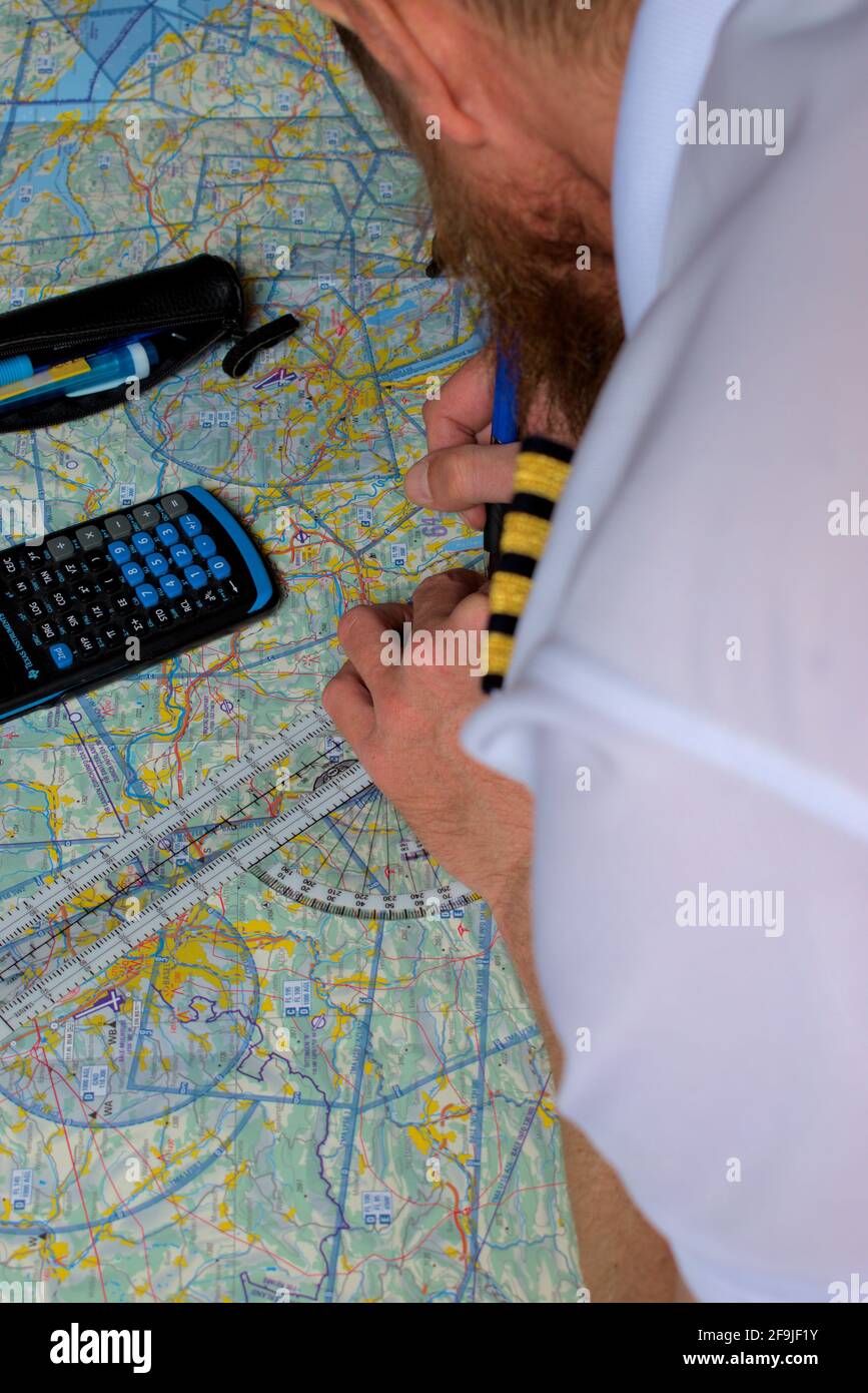 Pilot is calculating his navigation route on an actual map 25.3.2021 ...