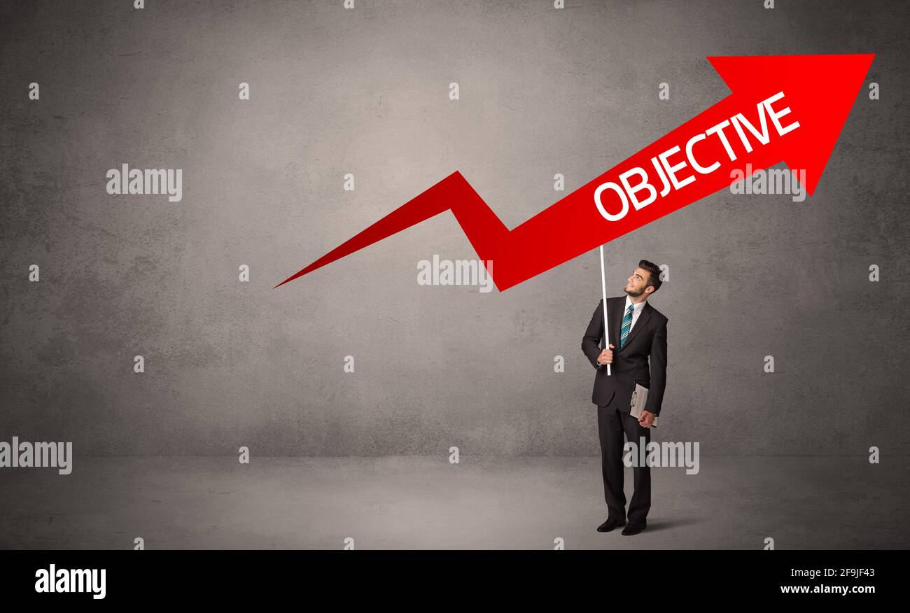 Young business person in casual holding road sign Stock Photo - Alamy