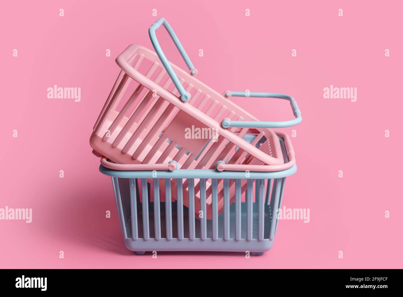 Colorful plastic shopping baskets. Empty pink and blue supermarket ...