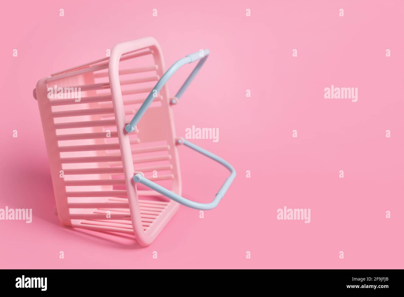Colorful plastic shopping baskets. Empty pink and blue supermarket ...