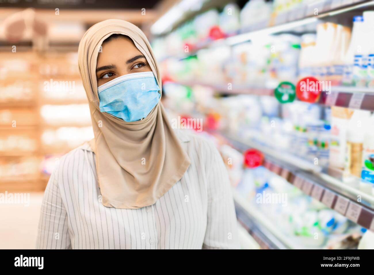 Muslim Lady In Face Mask Doing Grocery Shopping In Supermarket Stock ...