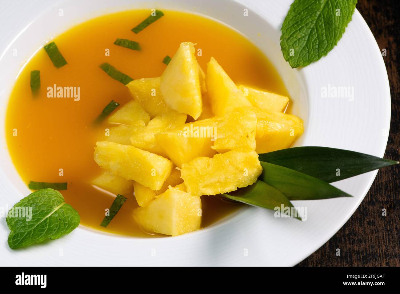 Fresh pineapple dessert recipe with mint orange coulis Stock Photo - Alamy