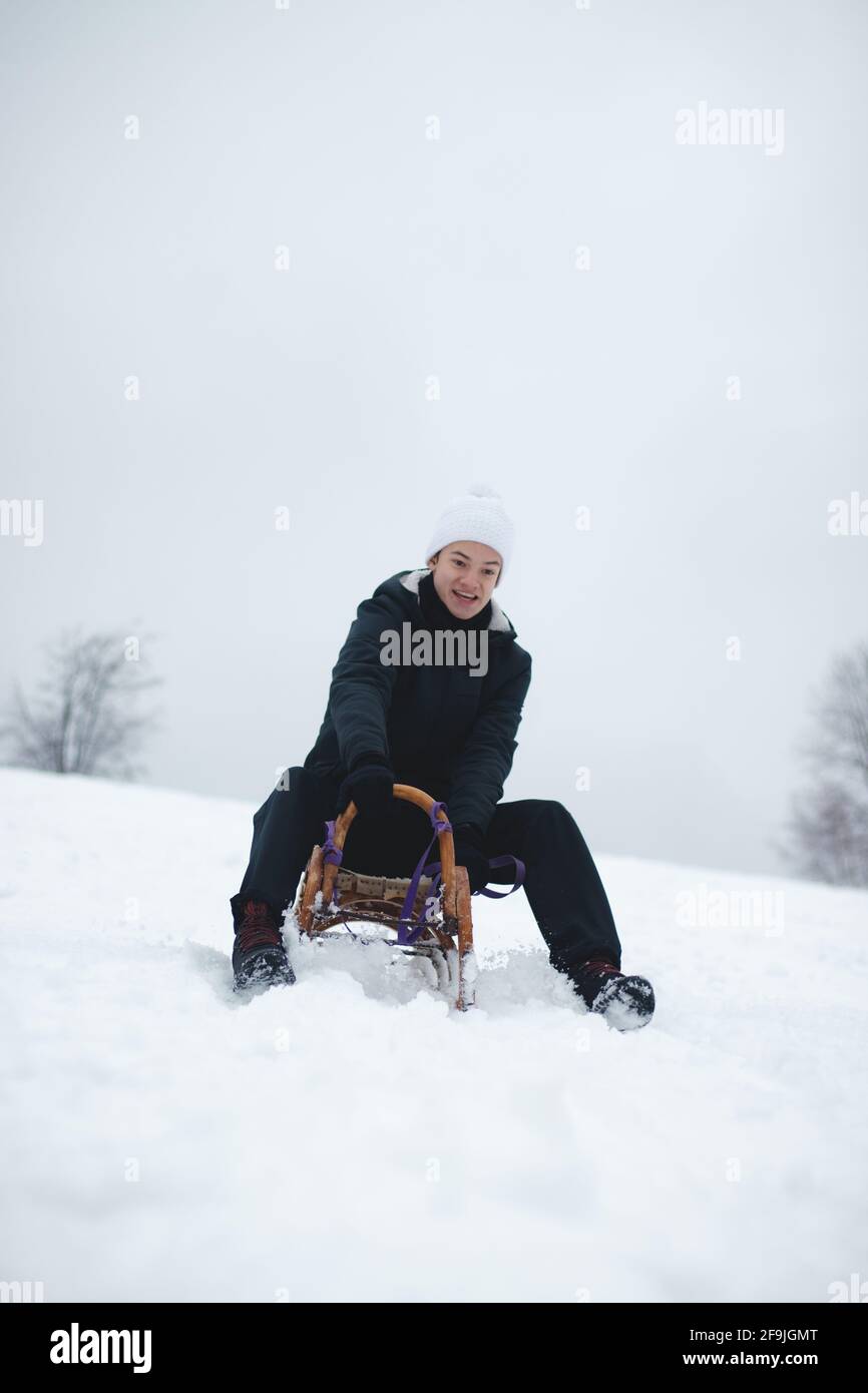 Joyful smile of a young sixteen year old boy riding a historic wooden ...