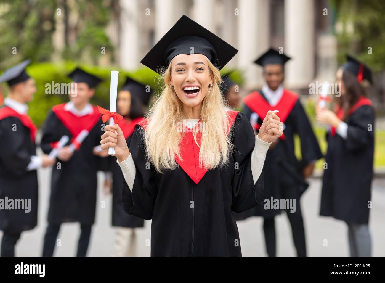 Emotional blonde lady student having graduation party Stock Photo - Alamy