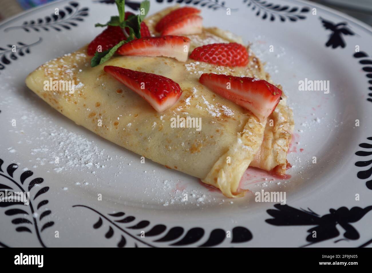 Closeup of a crepe with strawberry, mint garnish at a luxury resort in ...