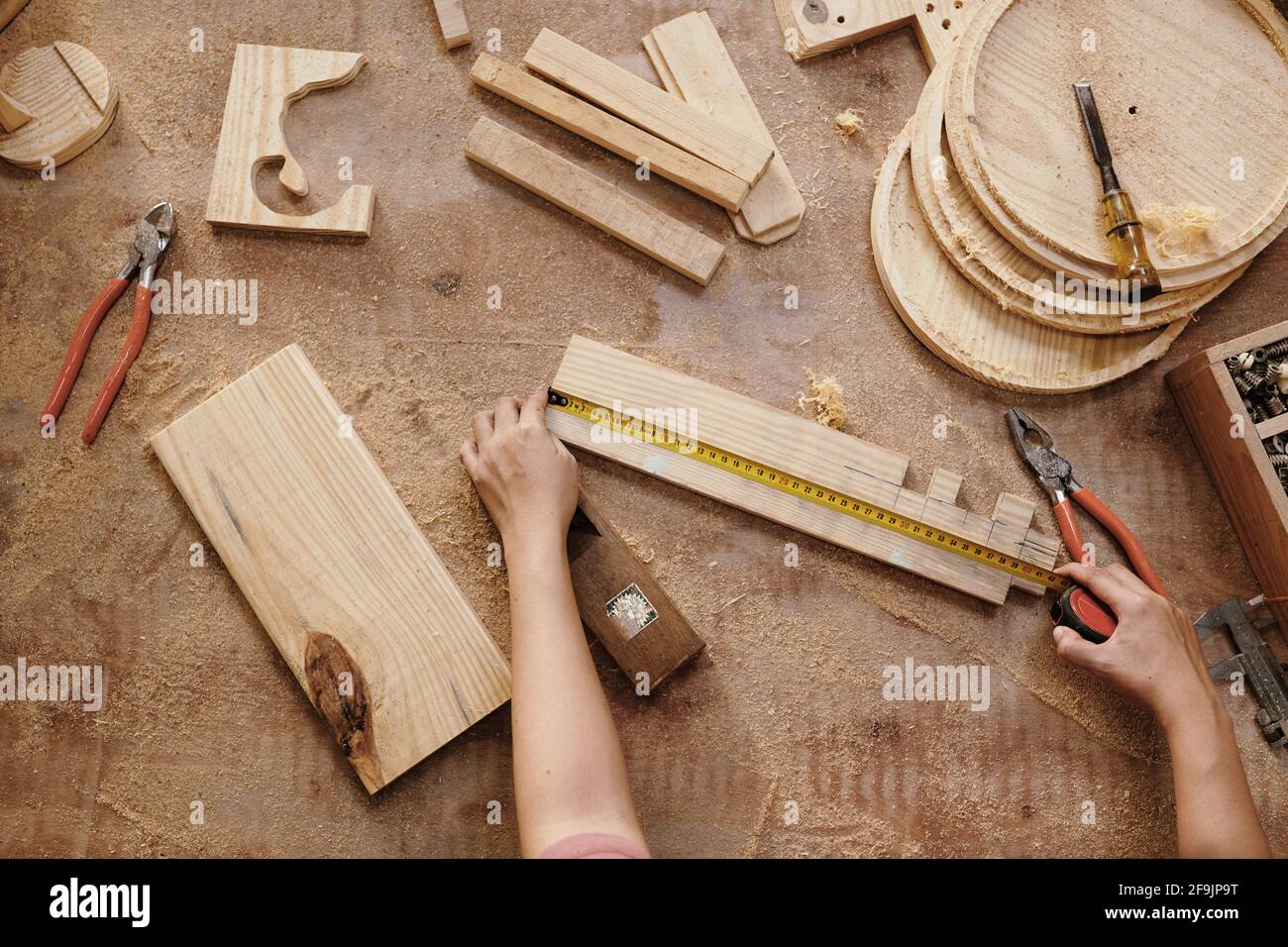 Hands of carpenter measuring wooden details, view from above Stock ...