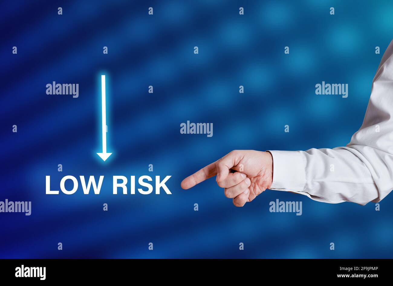 Businessman hand points to the word low risk with arrow icon ...