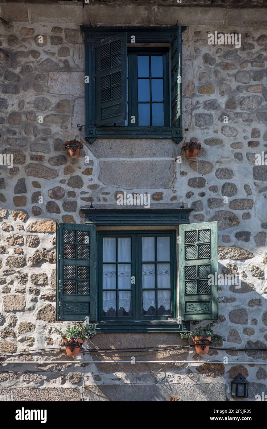 View of a rustic granite stone masonry facade of a traditional ...
