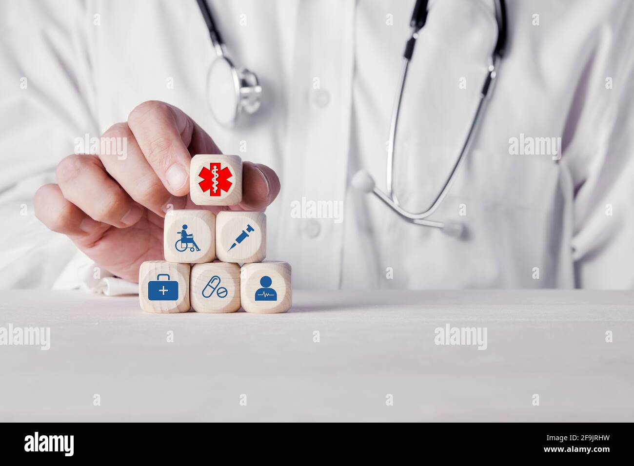 Hand of a doctor placing wooden cubes with medical health icons. Health ...