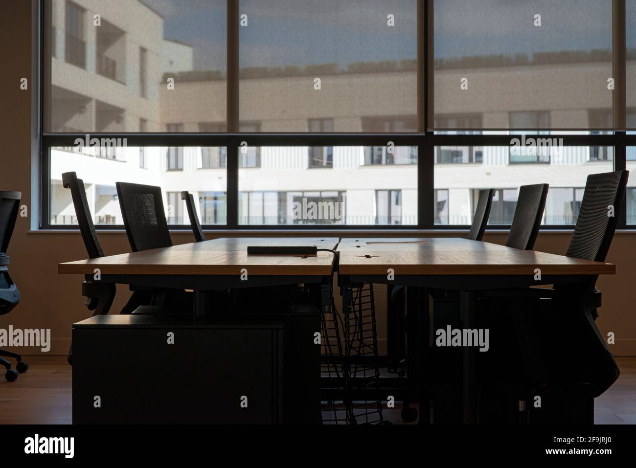 Empty communal office desk Stock Photo - Alamy