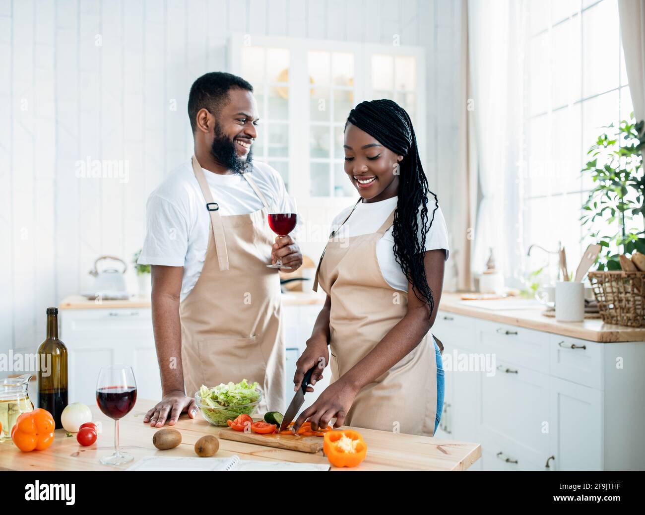 Man cooking woman drink wine hi-res stock photography and images - Alamy