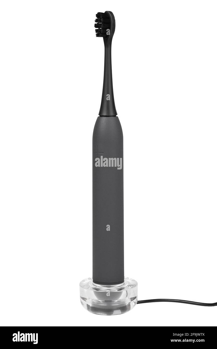 Modern electric toothbrush gray color on a stand with a charger ...