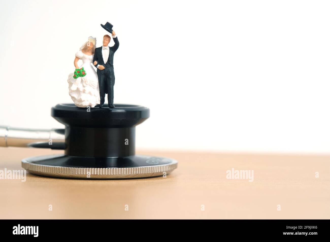 Wedding marriage and couple medical check-up concept miniature people ...