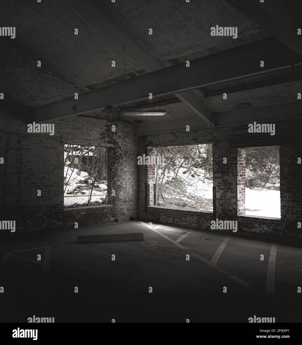 Light shining through the unfinished windows in an abandoned building ...