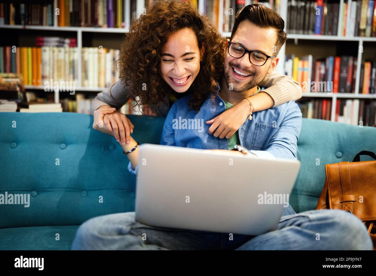 Students are studying together in library. Couple, study, technology ...