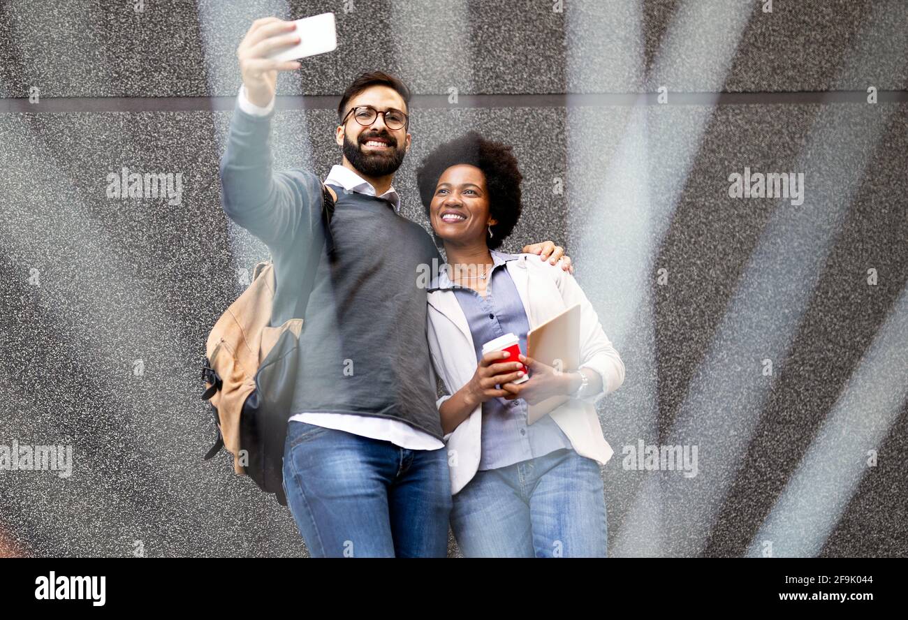 Happy couple having fun and taking a selfie. Smiling people enjoying ...