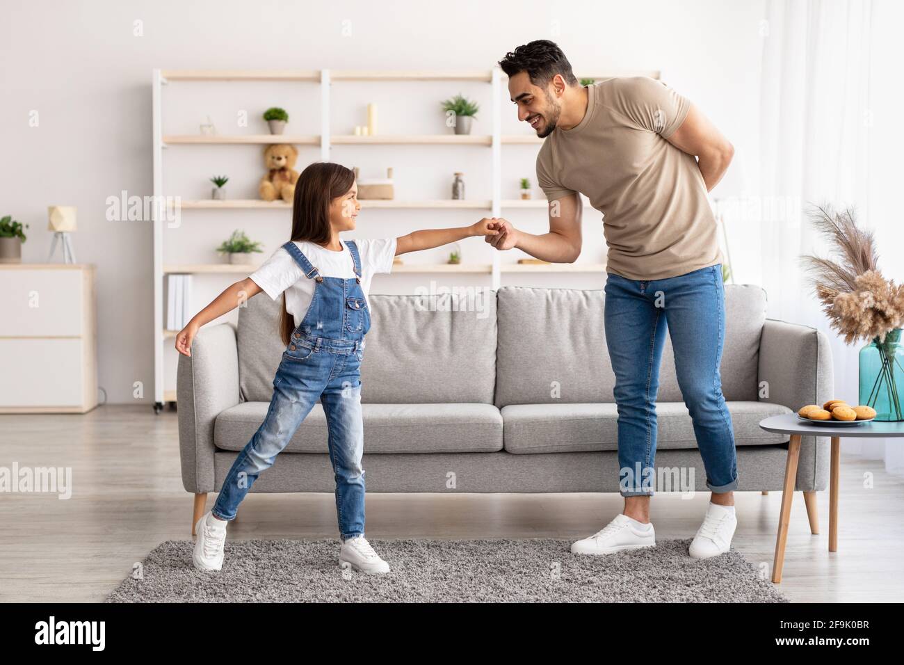 Dad and daughter dancing in living room together Stock Photo - Alamy