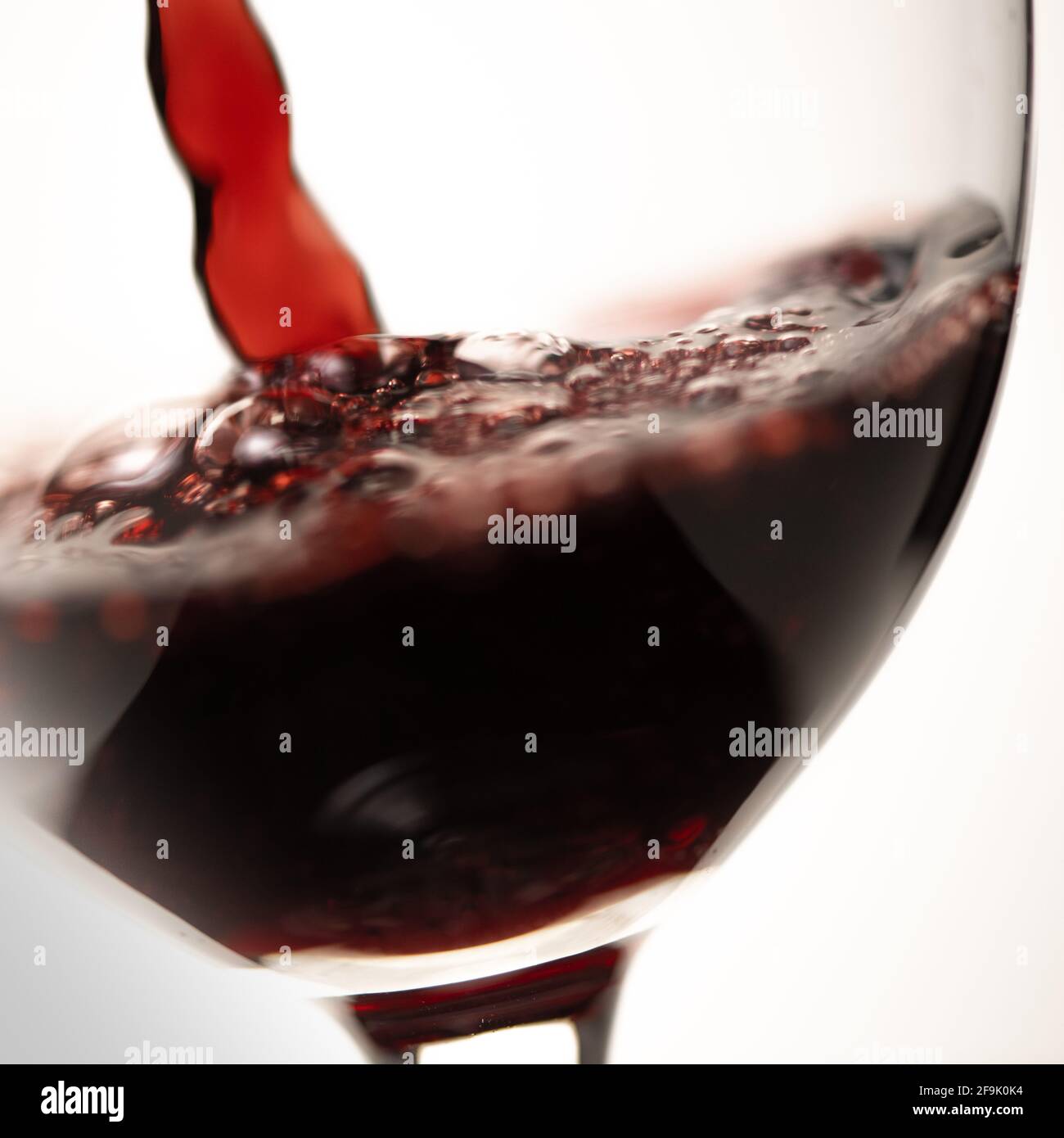 Red vine being pouring into a glass closeup vine splashing splash Stock ...