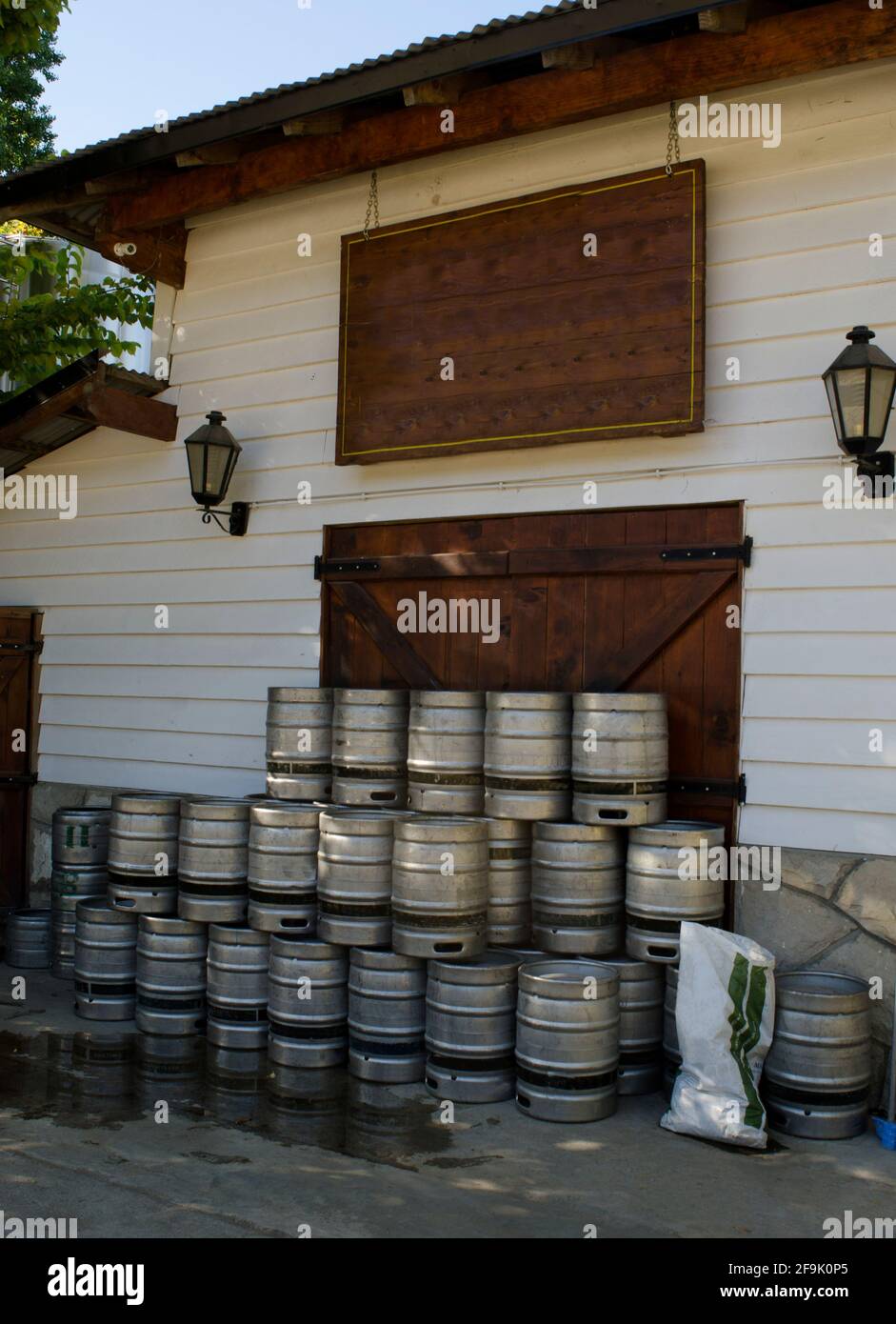 beer kegs stacked in front of craft brewery and distillery Stock Photo ...
