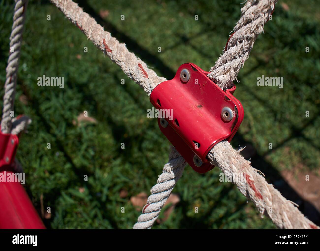 Red iron joints connect the rope together Stock Photo - Alamy